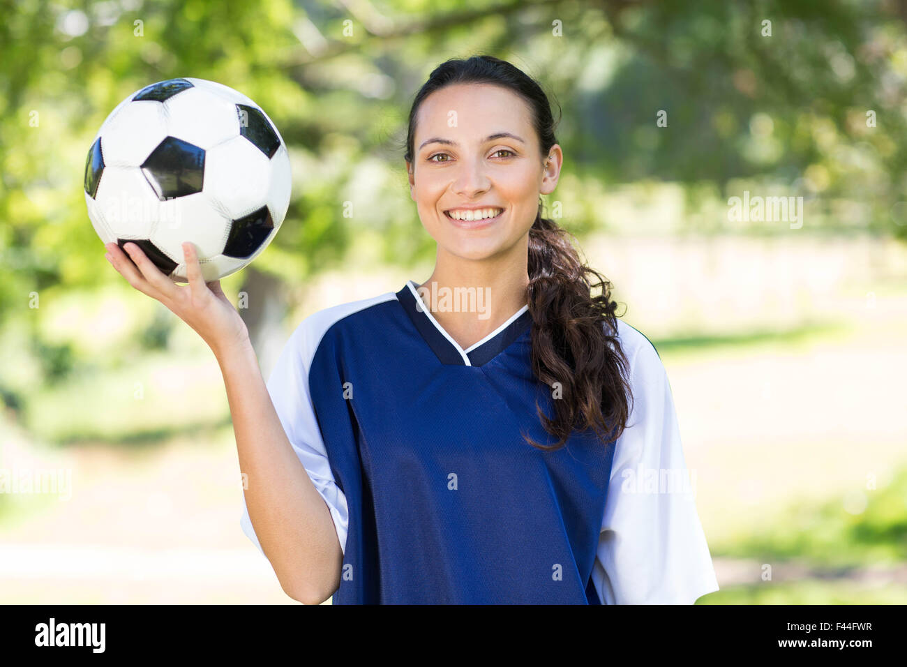Pretty football player smiling at camera Stock Photo - Alamy
