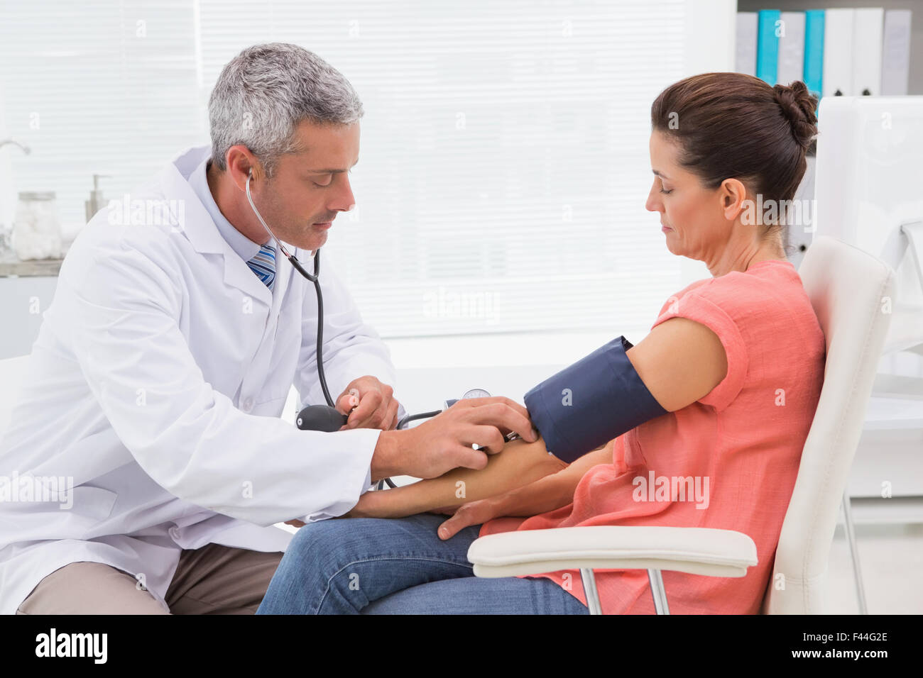 Doctor doing test at his patient Stock Photo - Alamy