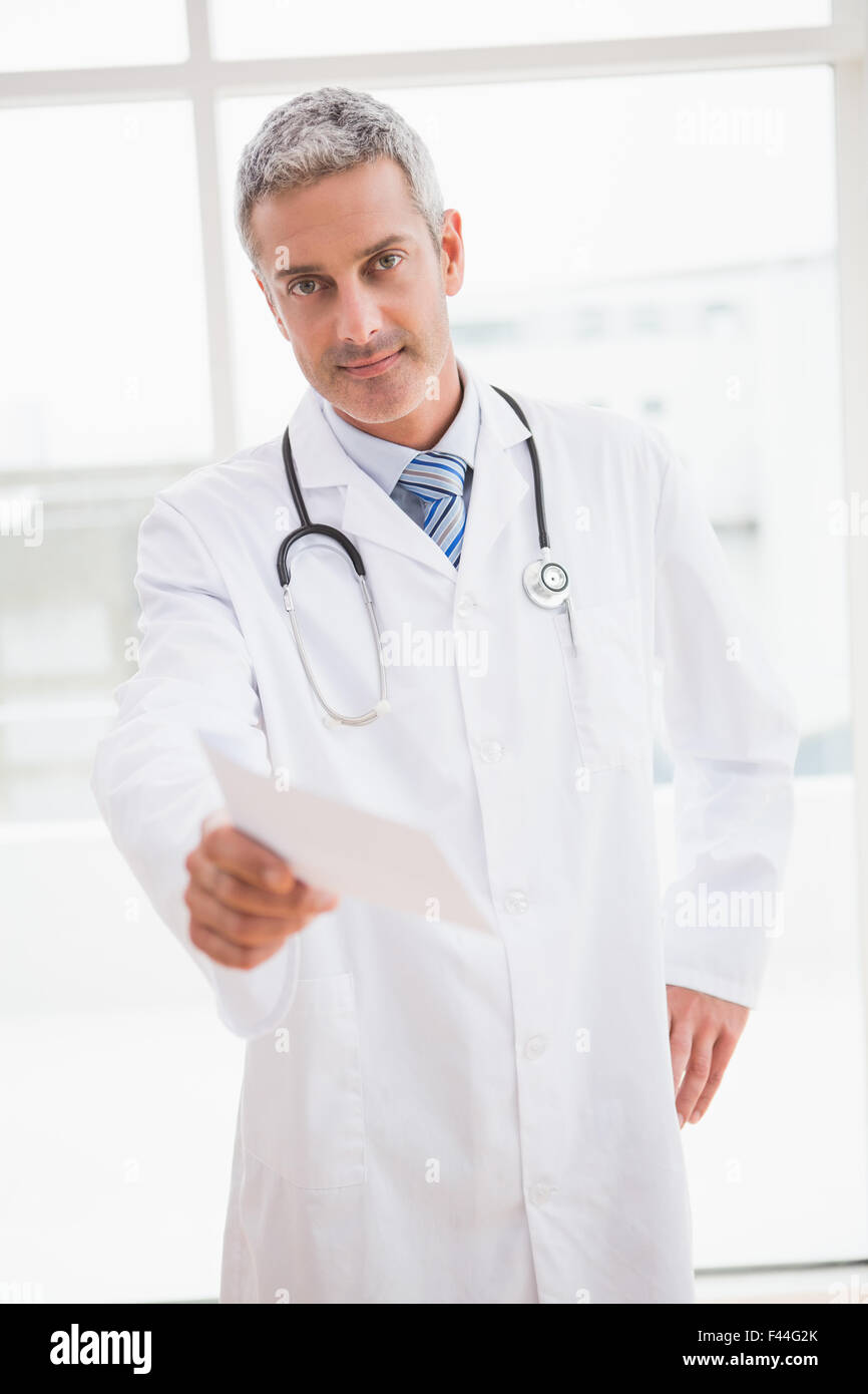 Doctor giving a paper Stock Photo - Alamy