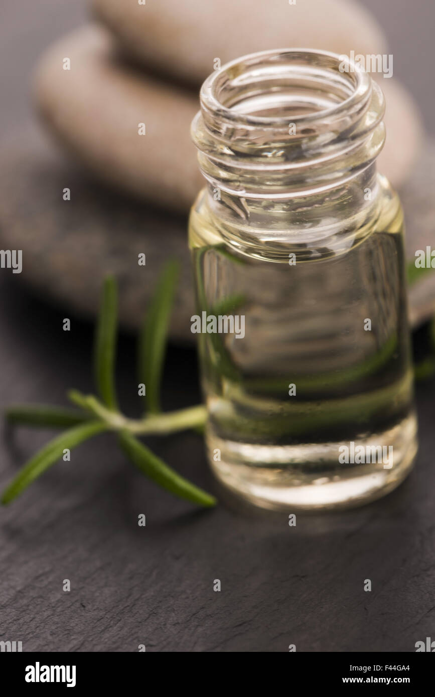 Essential oil with rosemary and fresh green leaves Stock Photo - Alamy