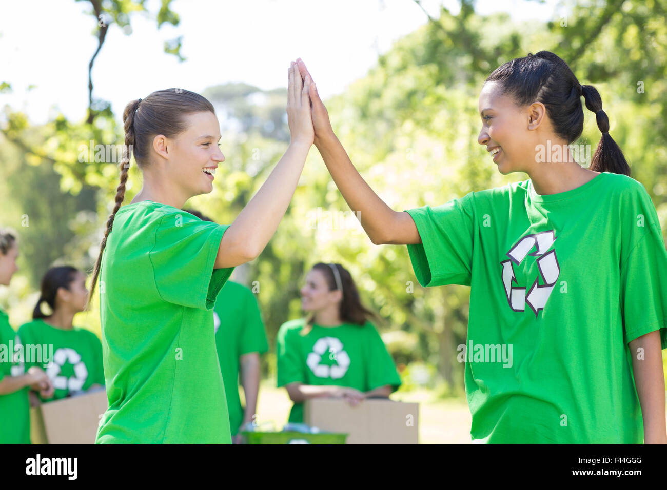Happy environmental activists in the park Stock Photo - Alamy