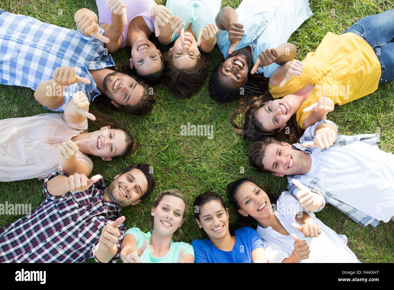 Happy friends in the park lying in circle Stock Photo - Alamy