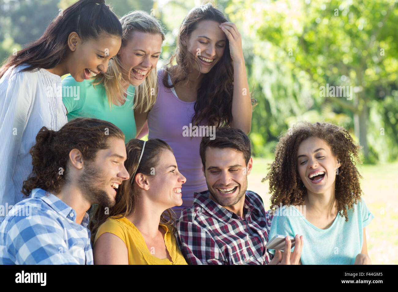 Smiling friends in the park Stock Photo - Alamy
