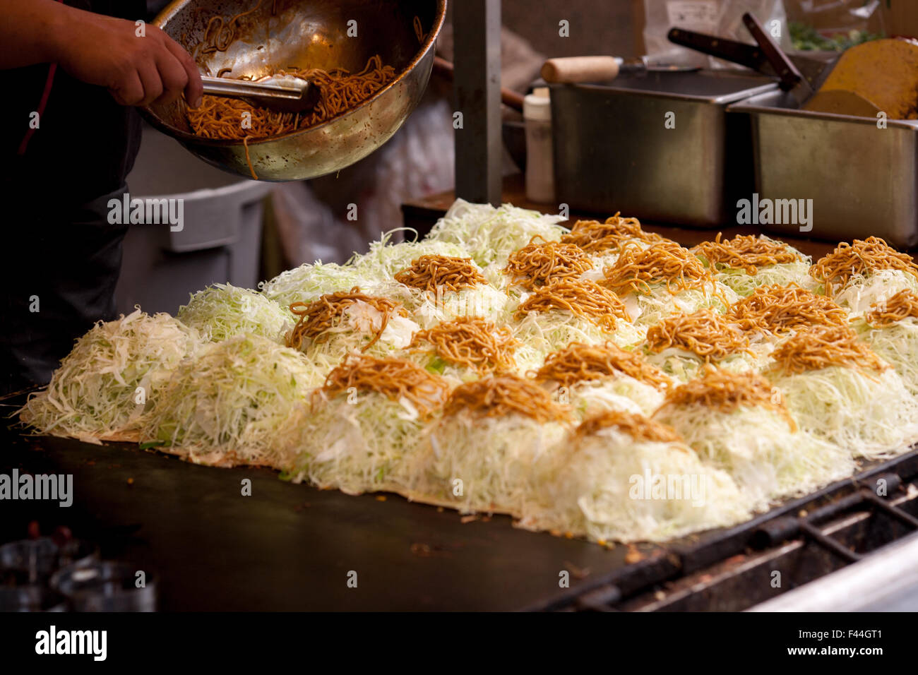 Japanese okonomi-yaki with soba noodles on top of cabbage side Stock ...