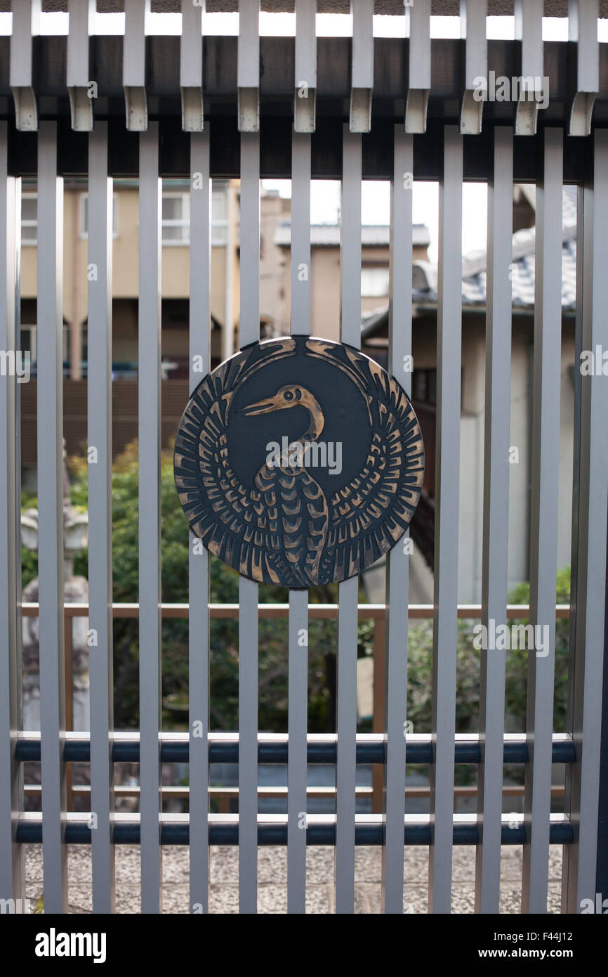 Crane emblem on metal gate Stock Photo - Alamy