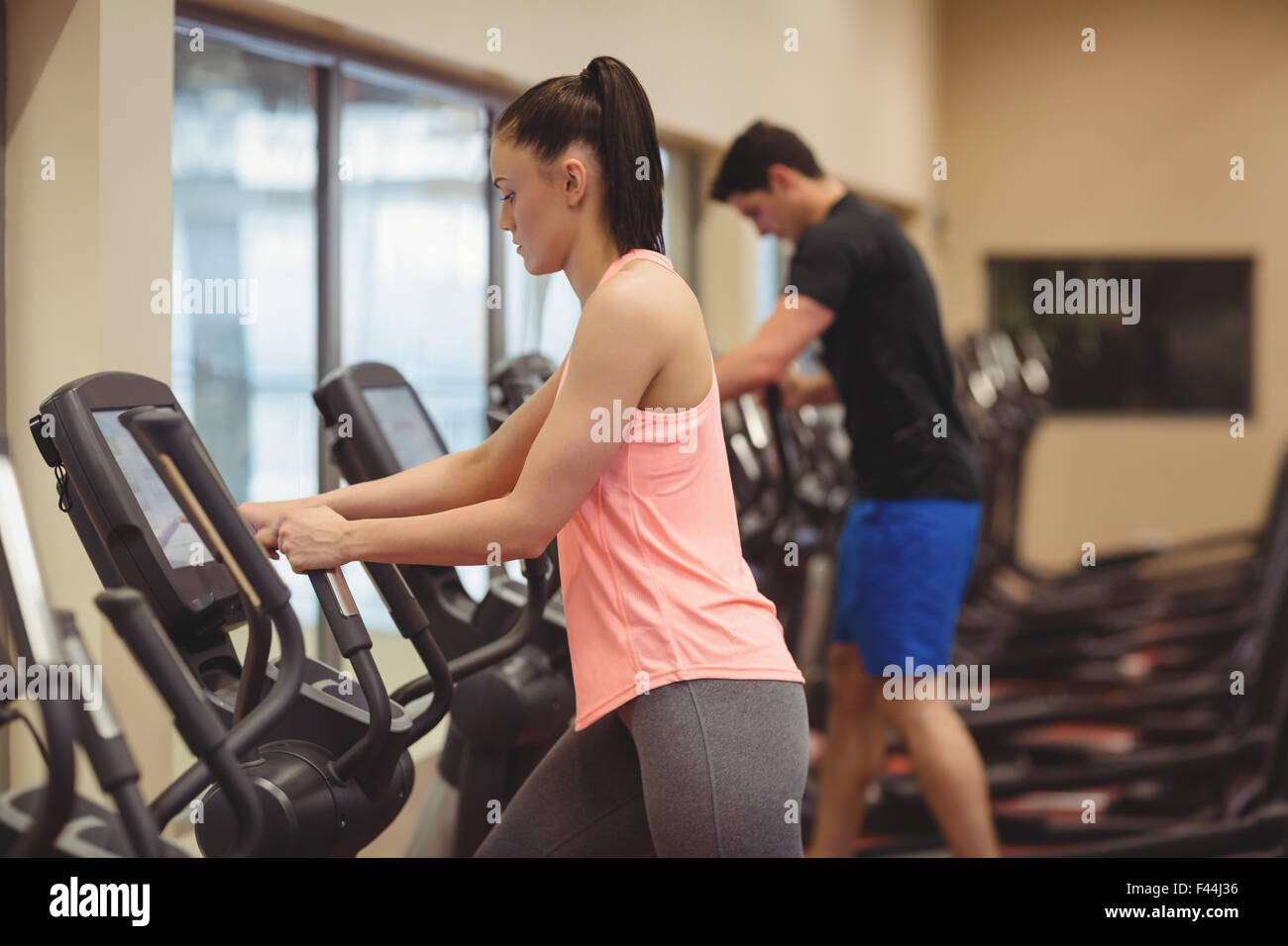 Fit people working out using machines Stock Photo - Alamy