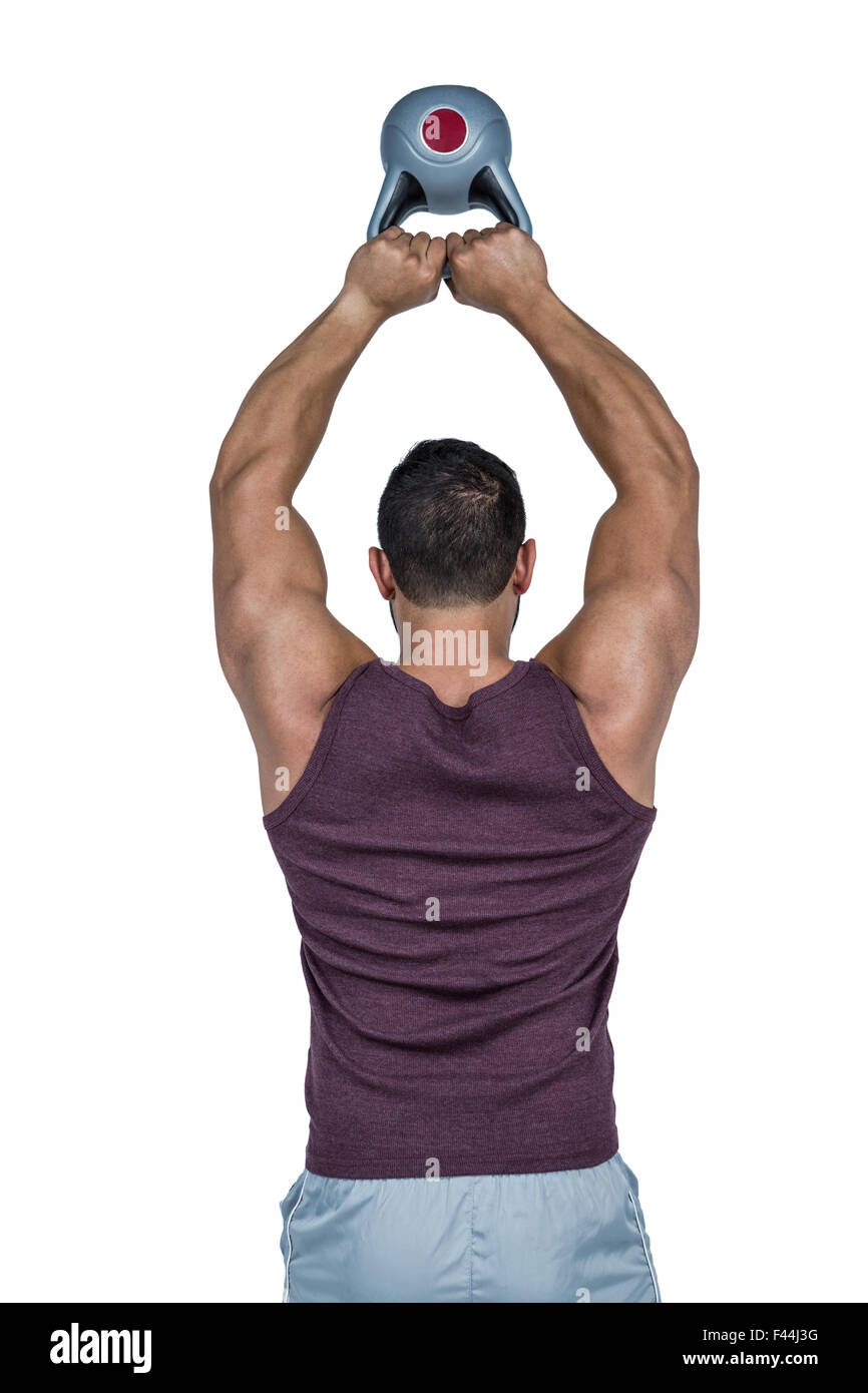 Muscular serious man lifting a kettlebell Stock Photo - Alamy