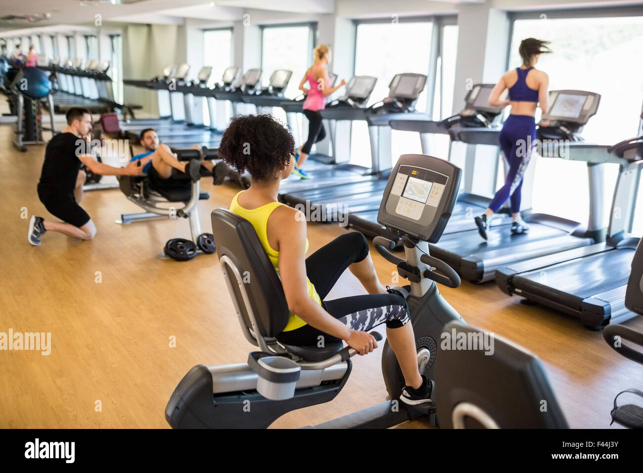 Fit people working out using machines Stock Photo - Alamy