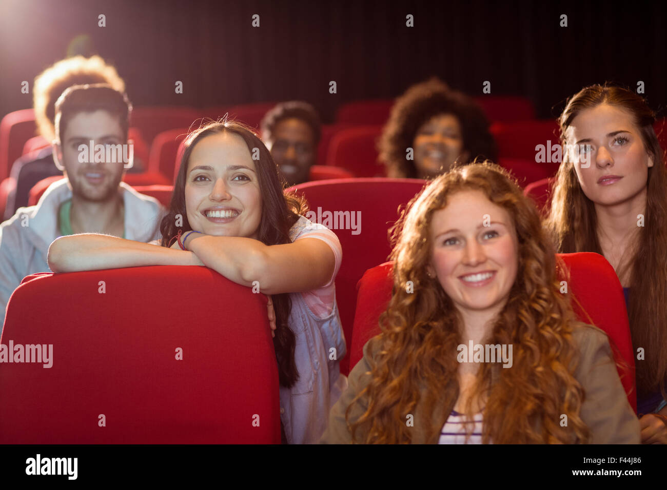 Young friends watching a film Stock Photo - Alamy