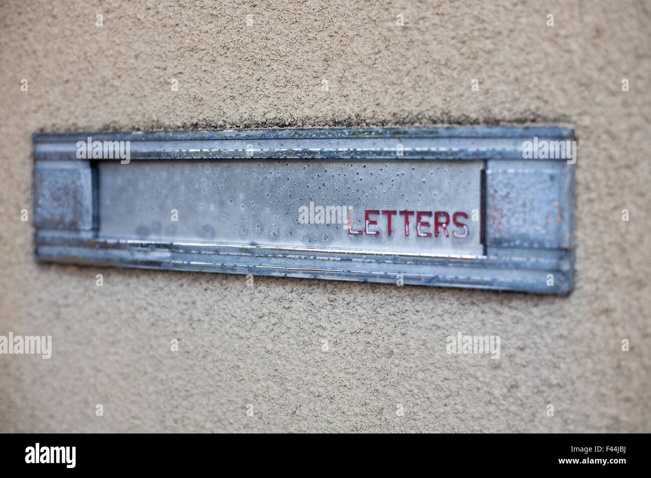 Rectangle metal mailbox in stucco wall Stock Photo - Alamy