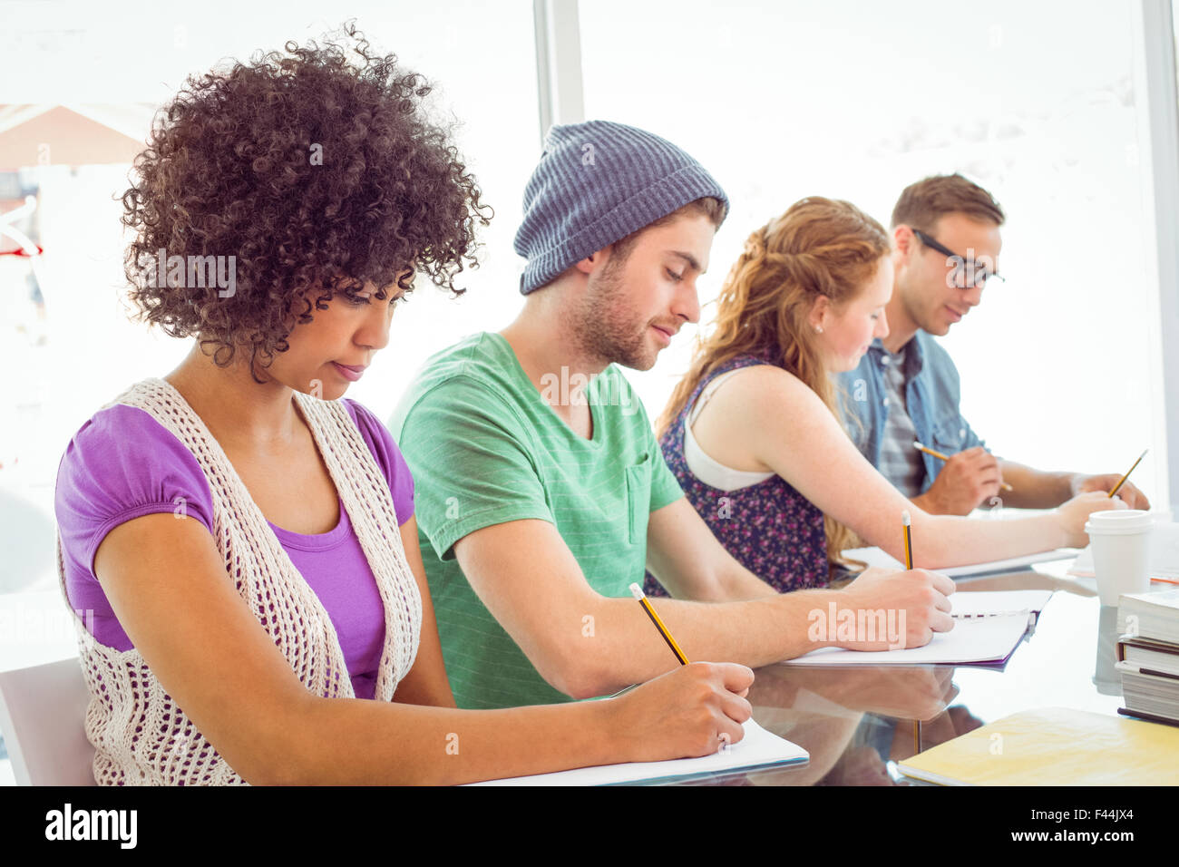 Fashion students writing on notepad Stock Photo - Alamy