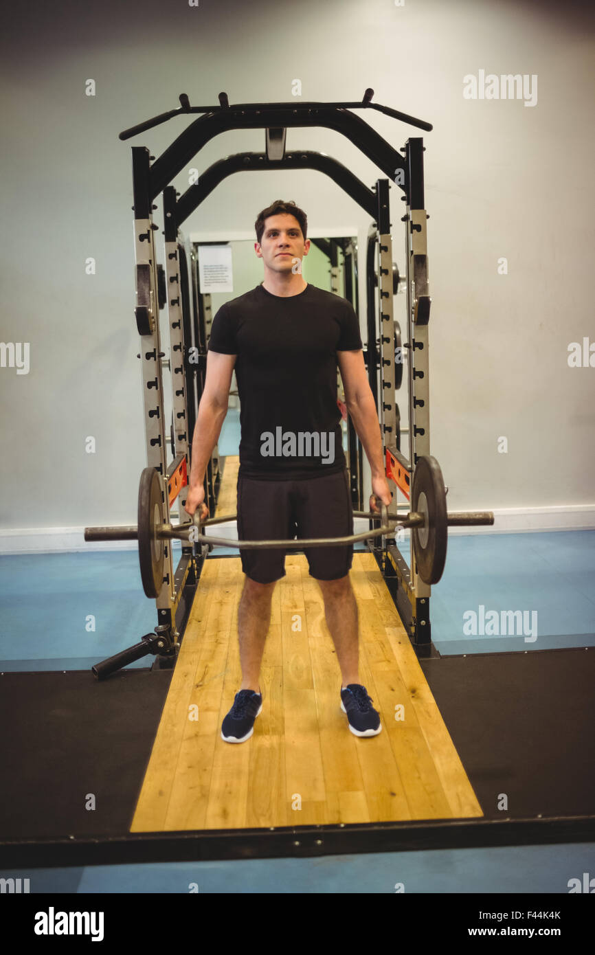 Fit man lifting heavy barbell Stock Photo - Alamy