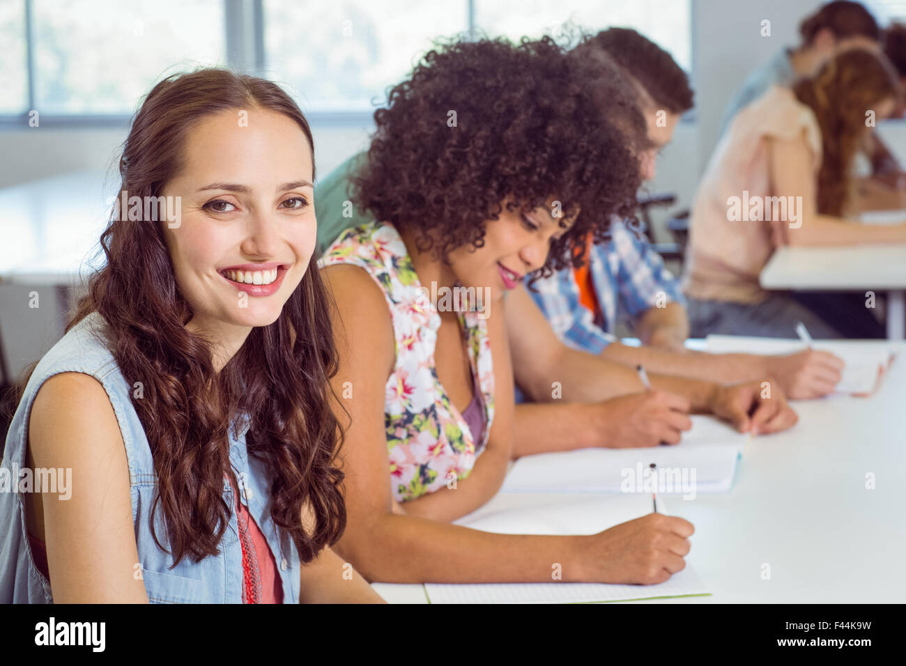 Fashion student taking notes in class Stock Photo - Alamy