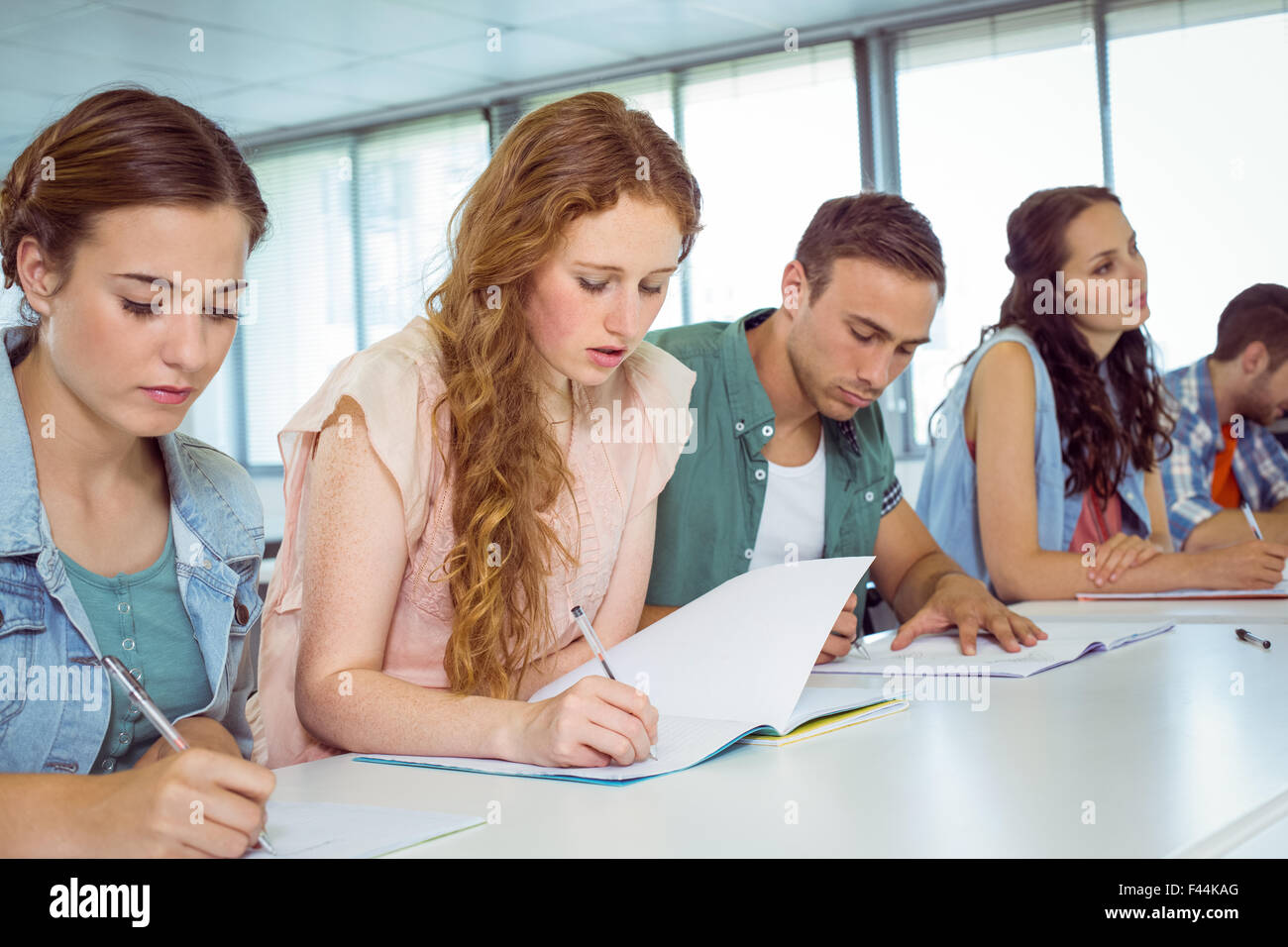 Fashion students taking notes in class Stock Photo - Alamy