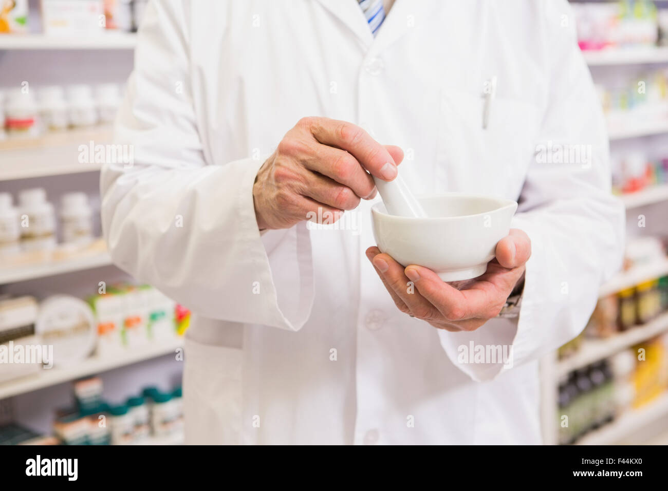 Mid section of pharmacist mixing medicine Stock Photo - Alamy