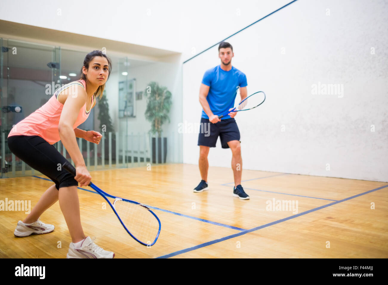 Couple play some squash together Stock Photo - Alamy