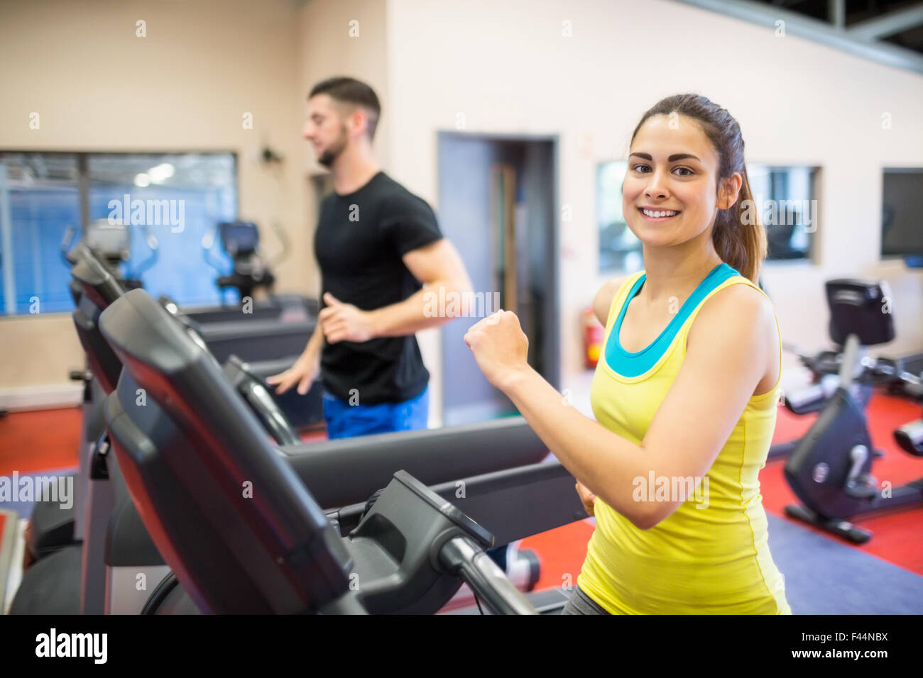 Man and woman using treadmills Stock Photo - Alamy