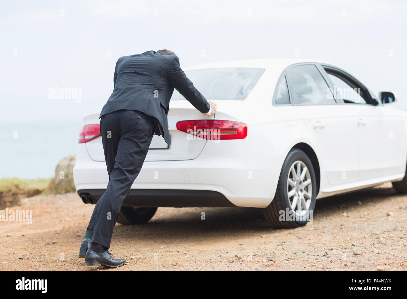 Businessman pushing his car Stock Photo - Alamy Businessman pushing his car Stock Photo - Alamy