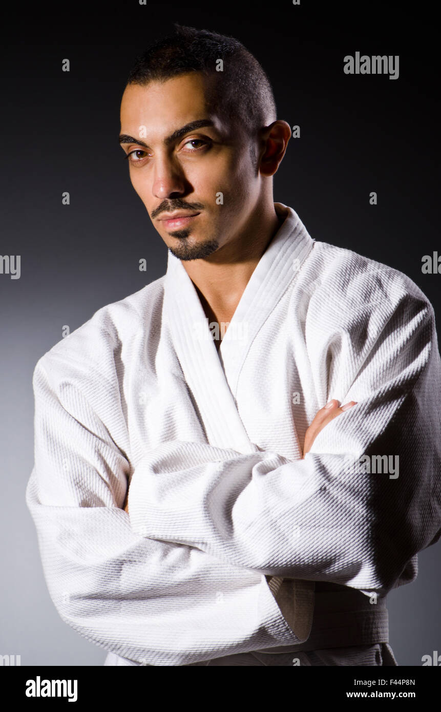 Karate player in dark room Stock Photo - Alamy