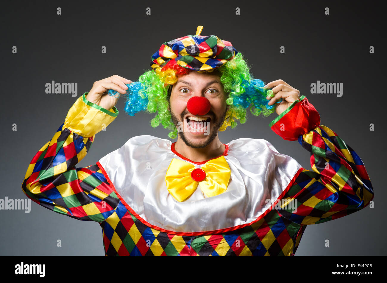 Funny clown in colourful costume Stock Photo - Alamy