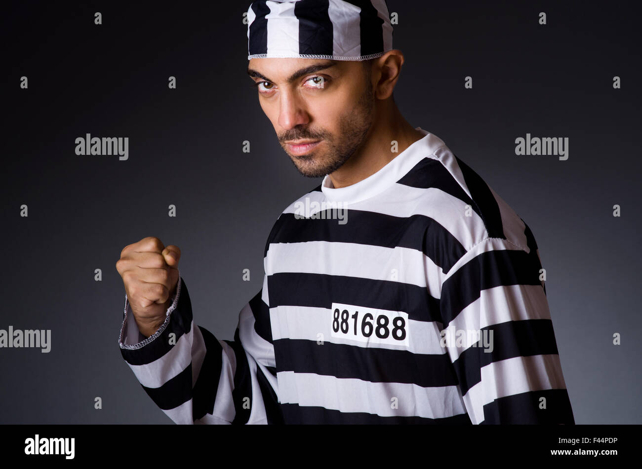Angry prison inmate in dark room Stock Photo - Alamy