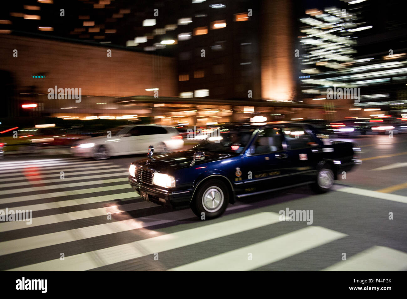 Blue taxi cab with motion blur at night Stock Photo - Alamy
