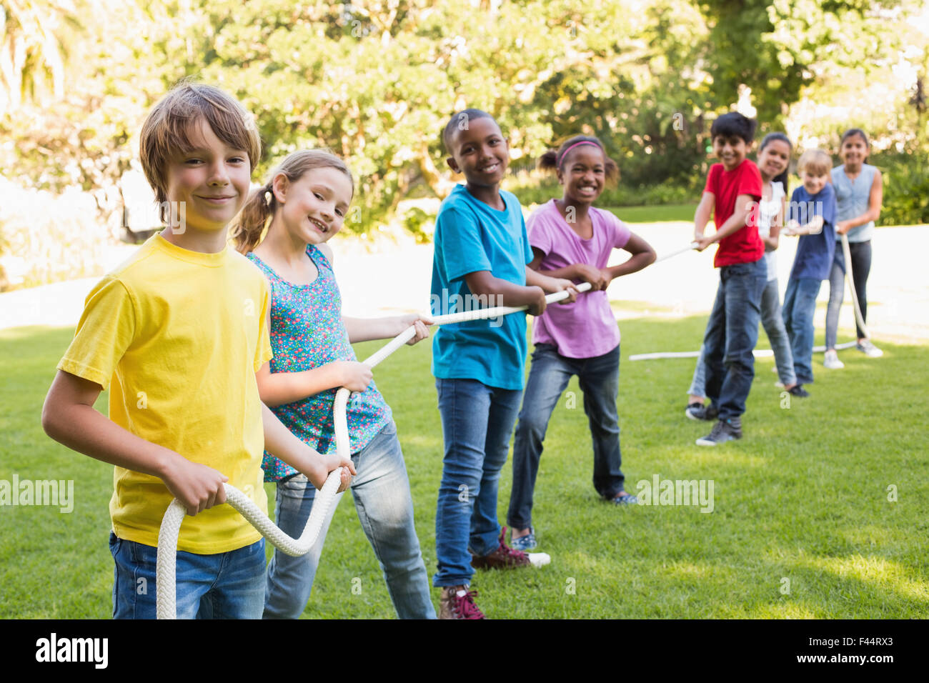 Happy friends playing in the park Stock Photo - Alamy