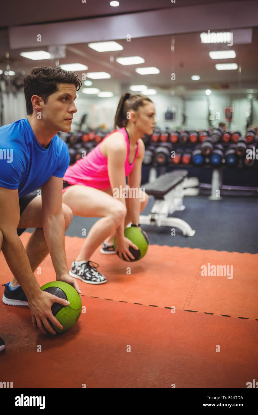 Fit couple working out in weights room Stock Photo - Alamy