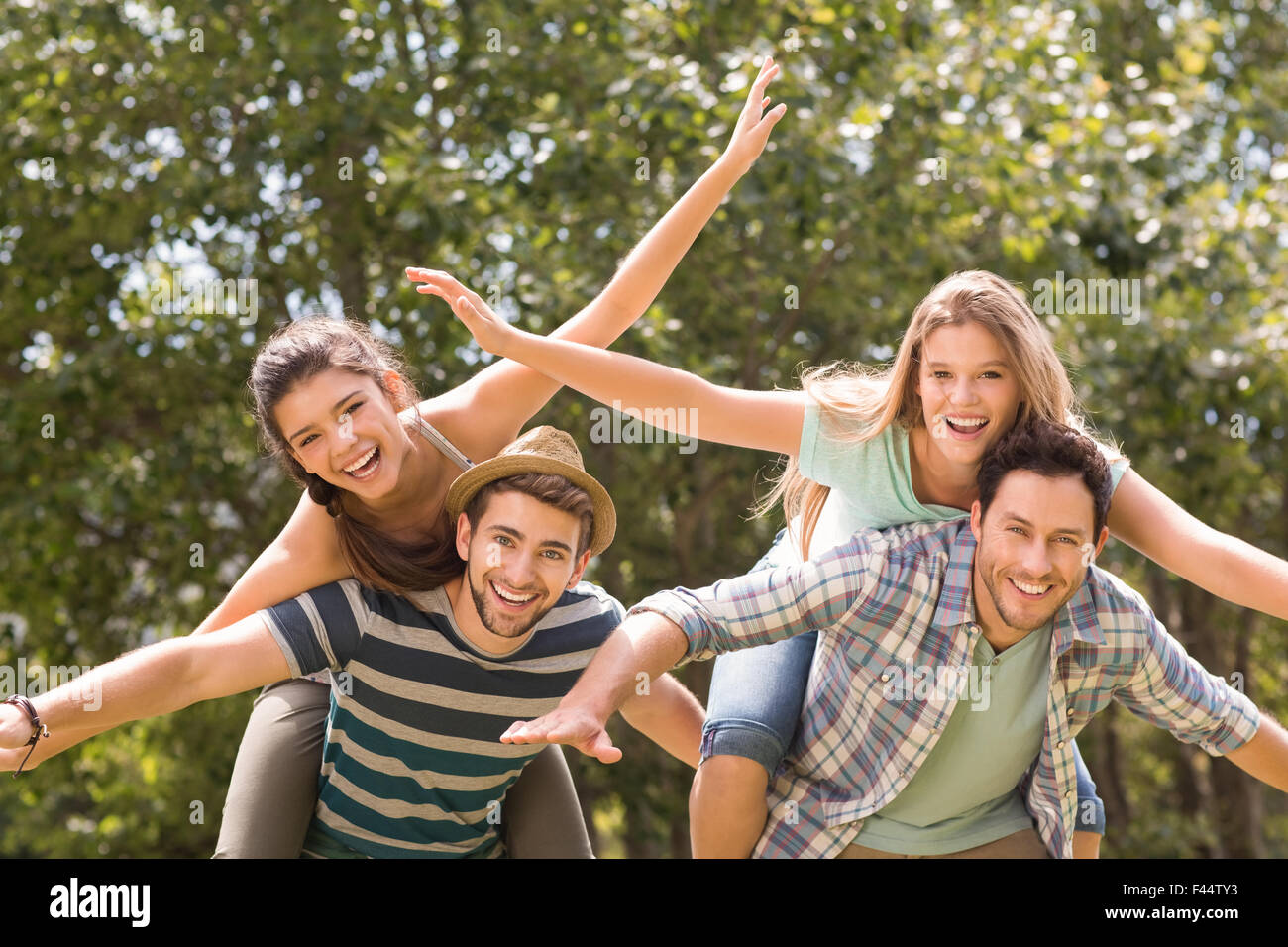 Happy friends in the park Stock Photo - Alamy