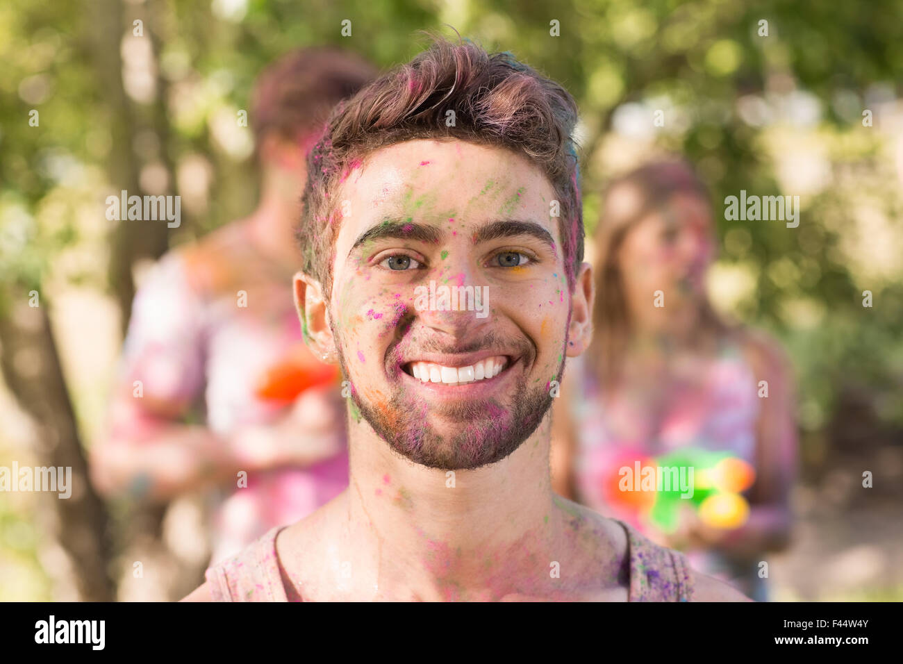 Happy boy covered in powder paint Stock Photo - Alamy