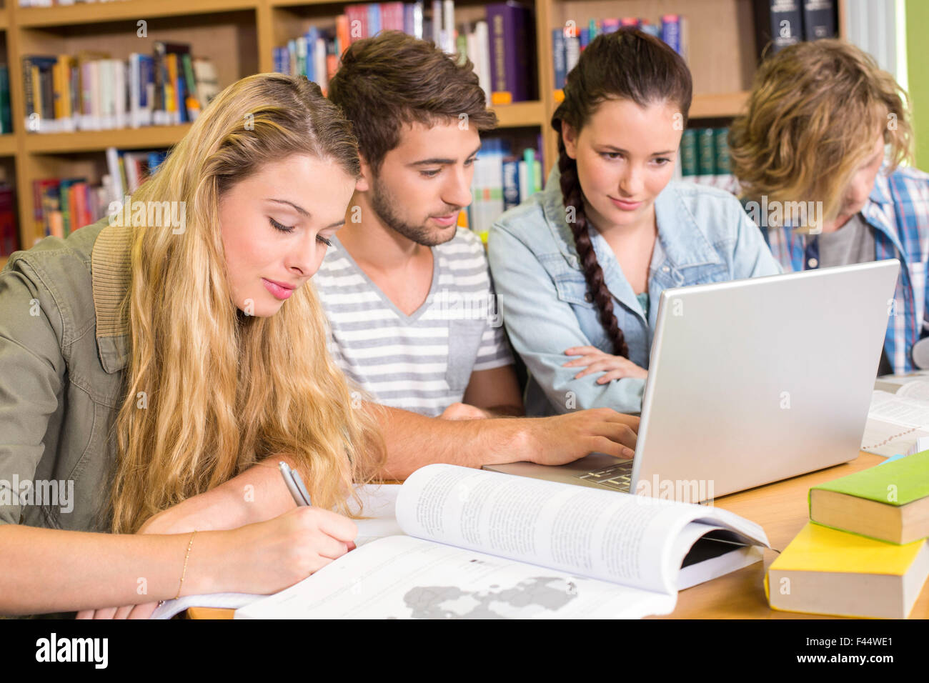 College students doing homework in library Stock Photo - Alamy