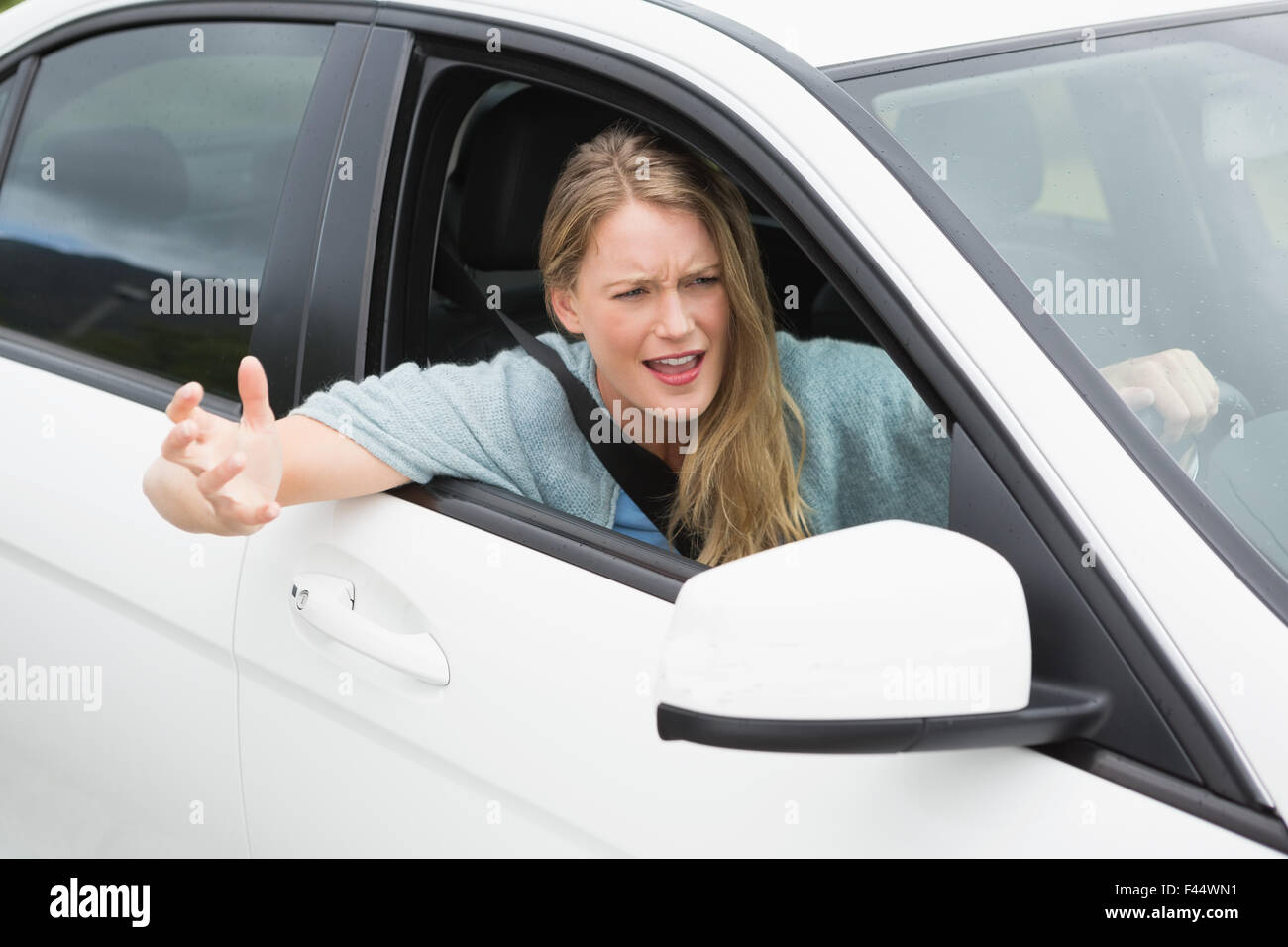 Young woman experiencing road rage Stock Photo - Alamy