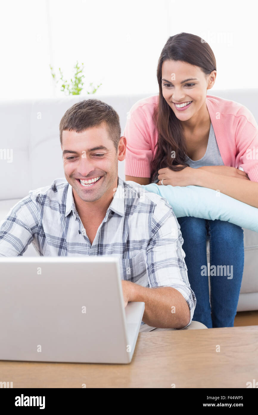 Couple using laptop together Stock Photo - Alamy