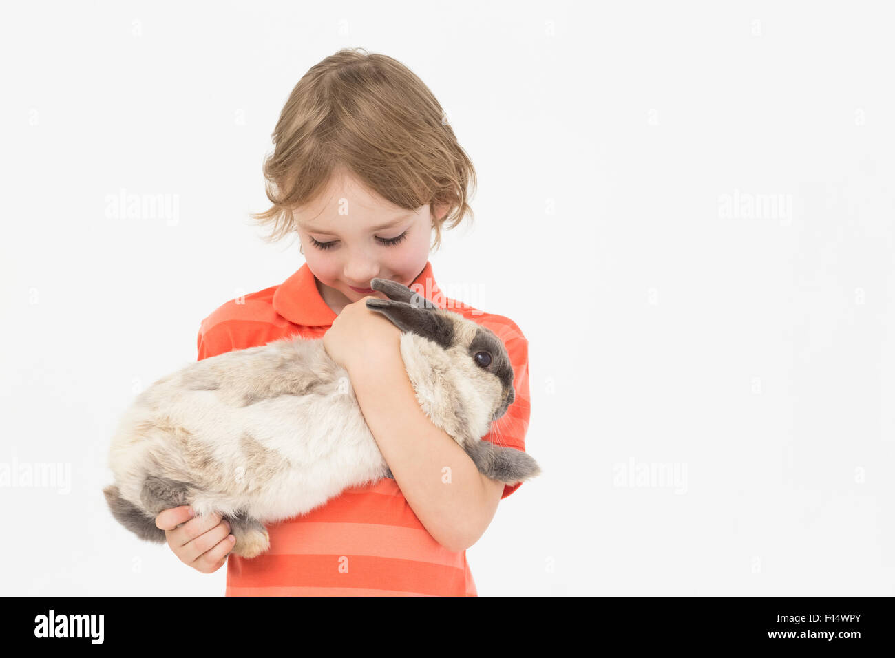 Cute boy holding bunny Stock Photo - Alamy