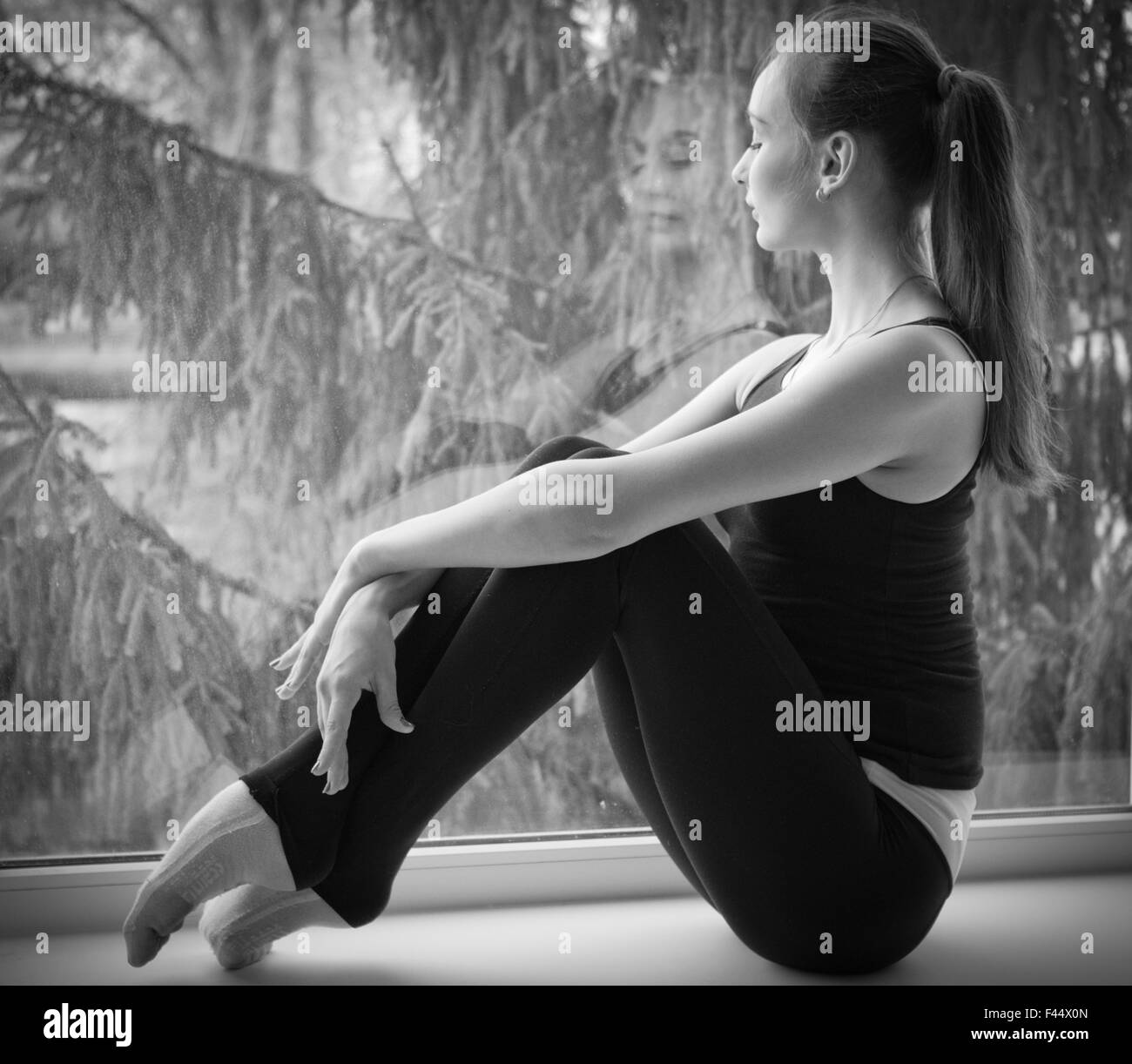 Young girl sit on window Stock Photo - Alamy