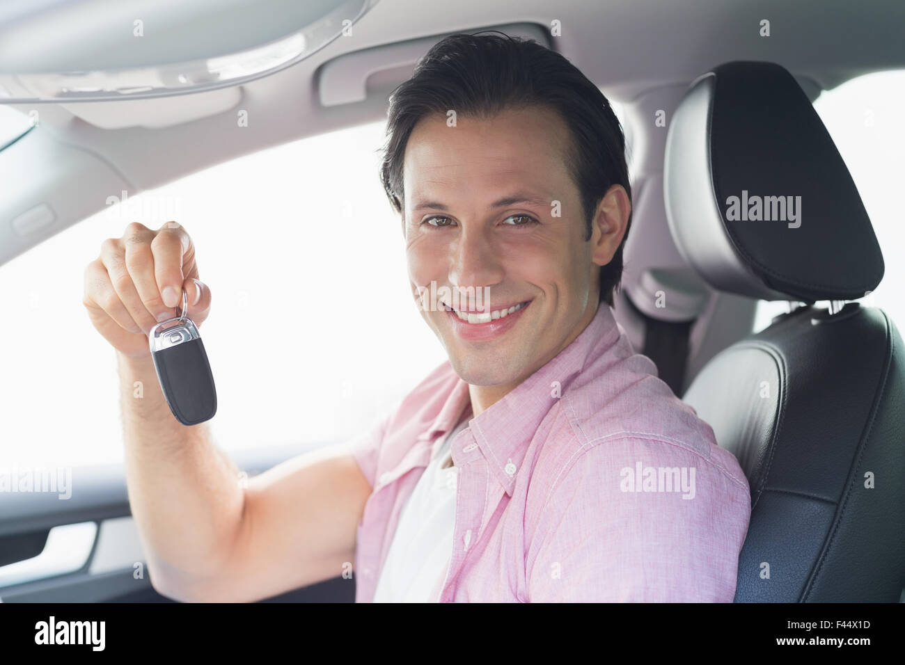 Man smiling at camera showing key Stock Photo - Alamy