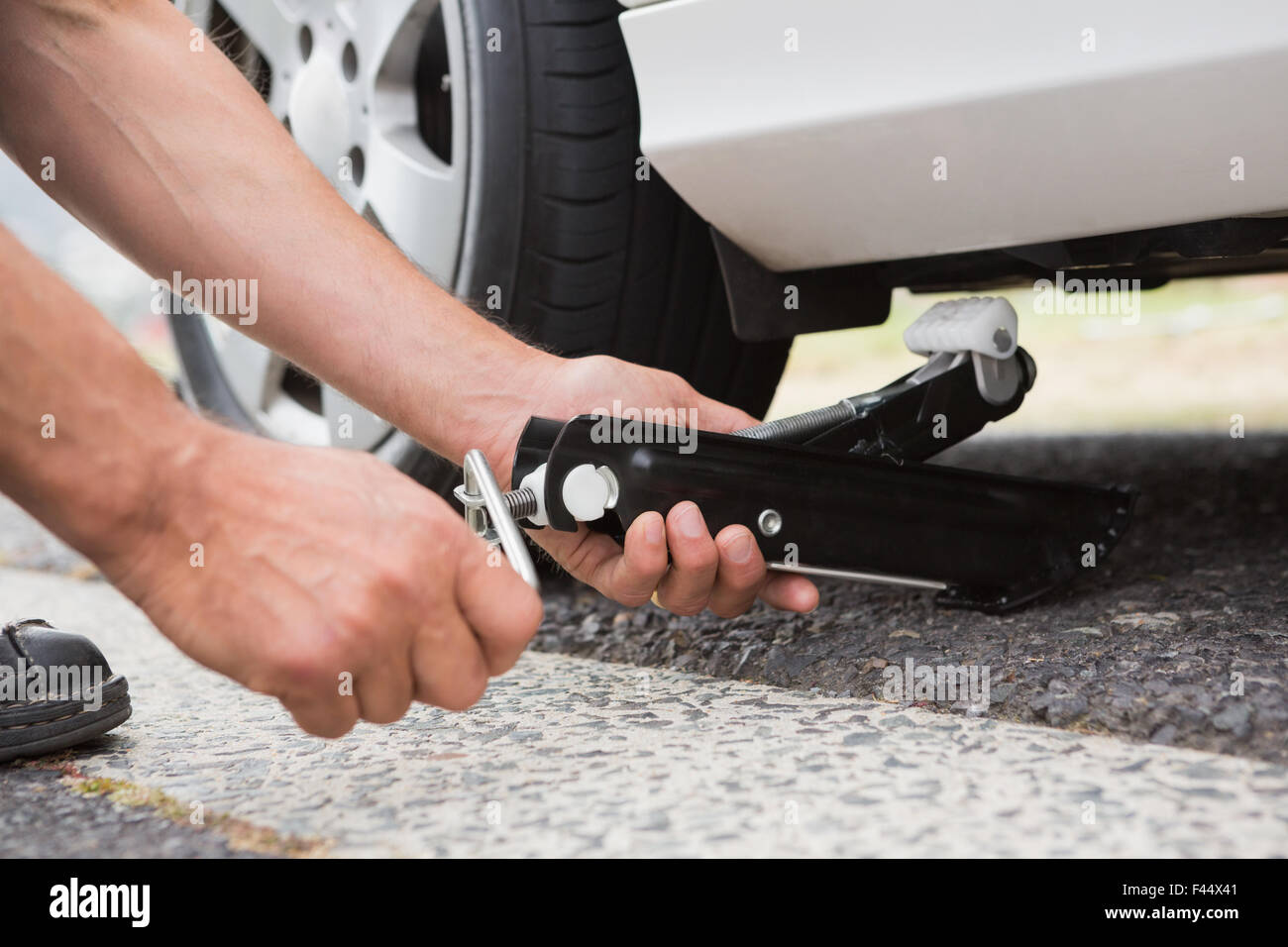 Man fixing tire Stock Photo - Alamy