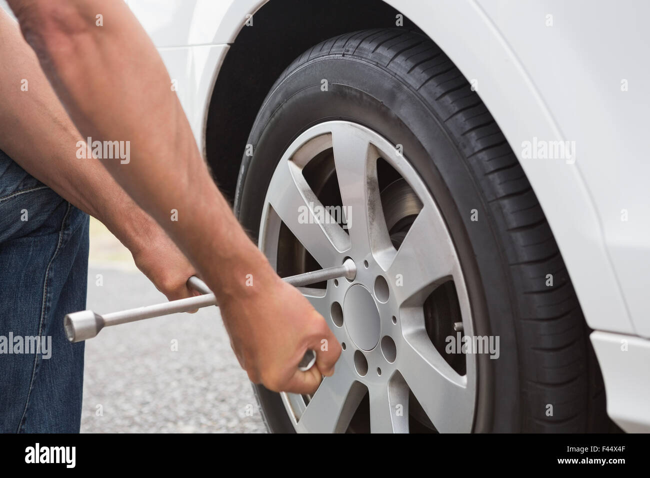 Man fixing tire Stock Photo - Alamy