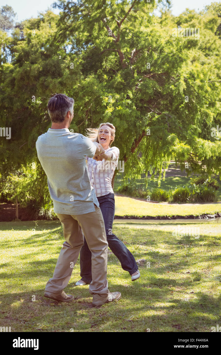 Happy couple dancing in the park Stock Photo - Alamy