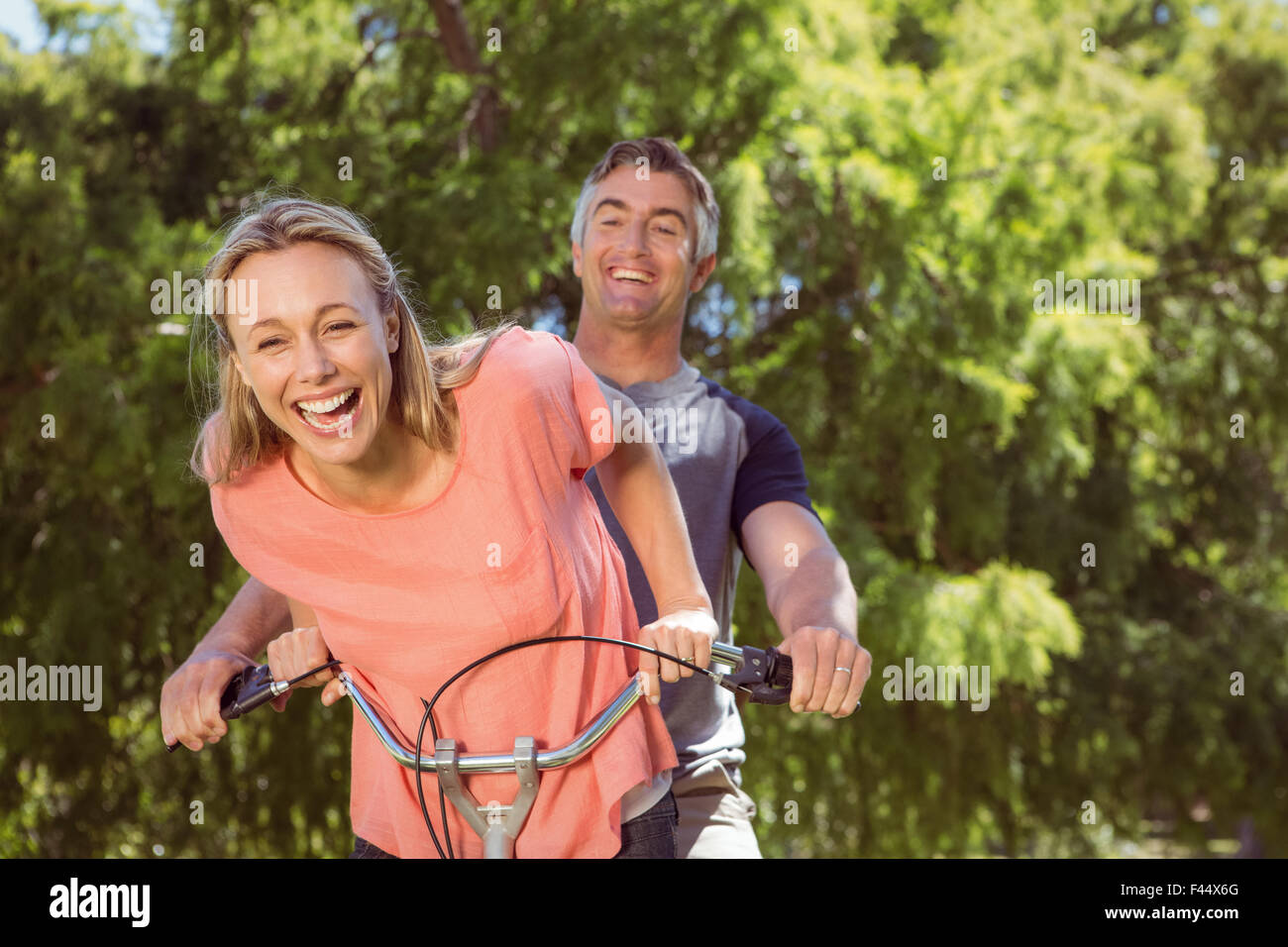 Happy couple on a bike ride Stock Photo - Alamy