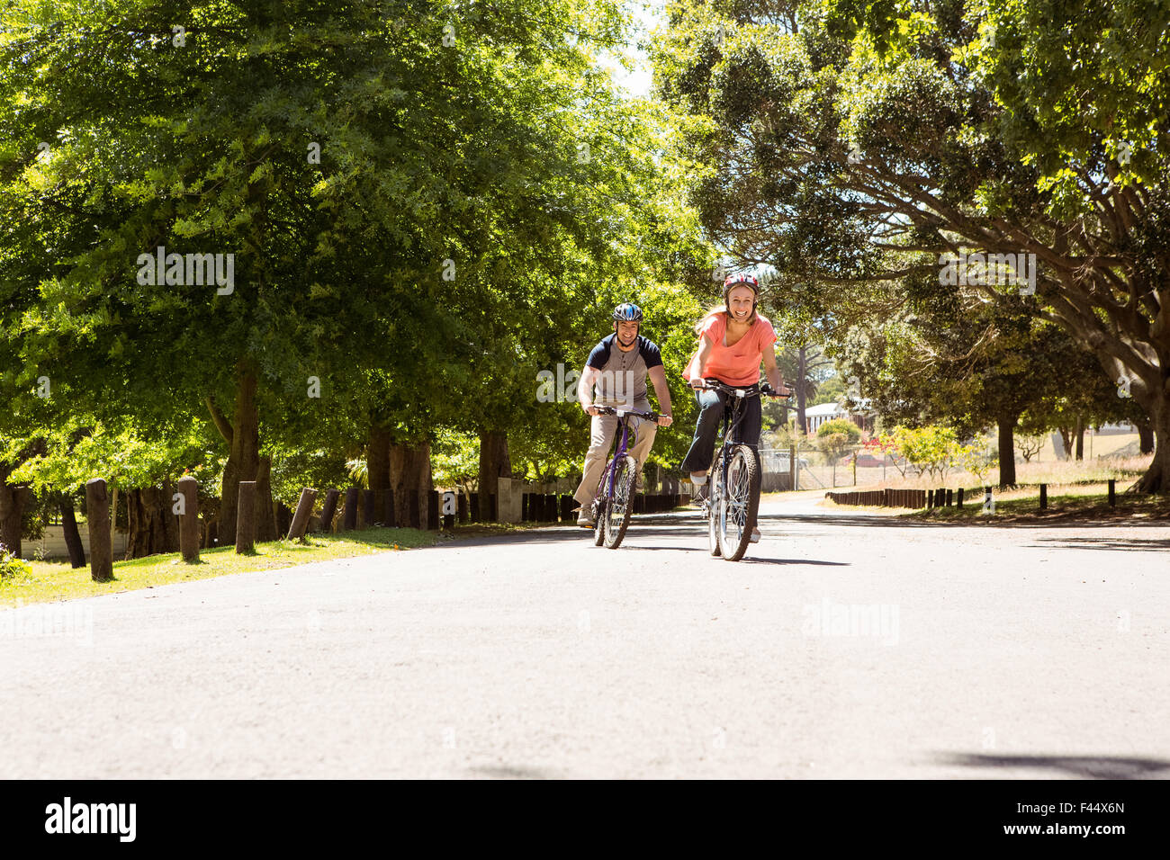 Happy couple on a bike ride Stock Photo - Alamy