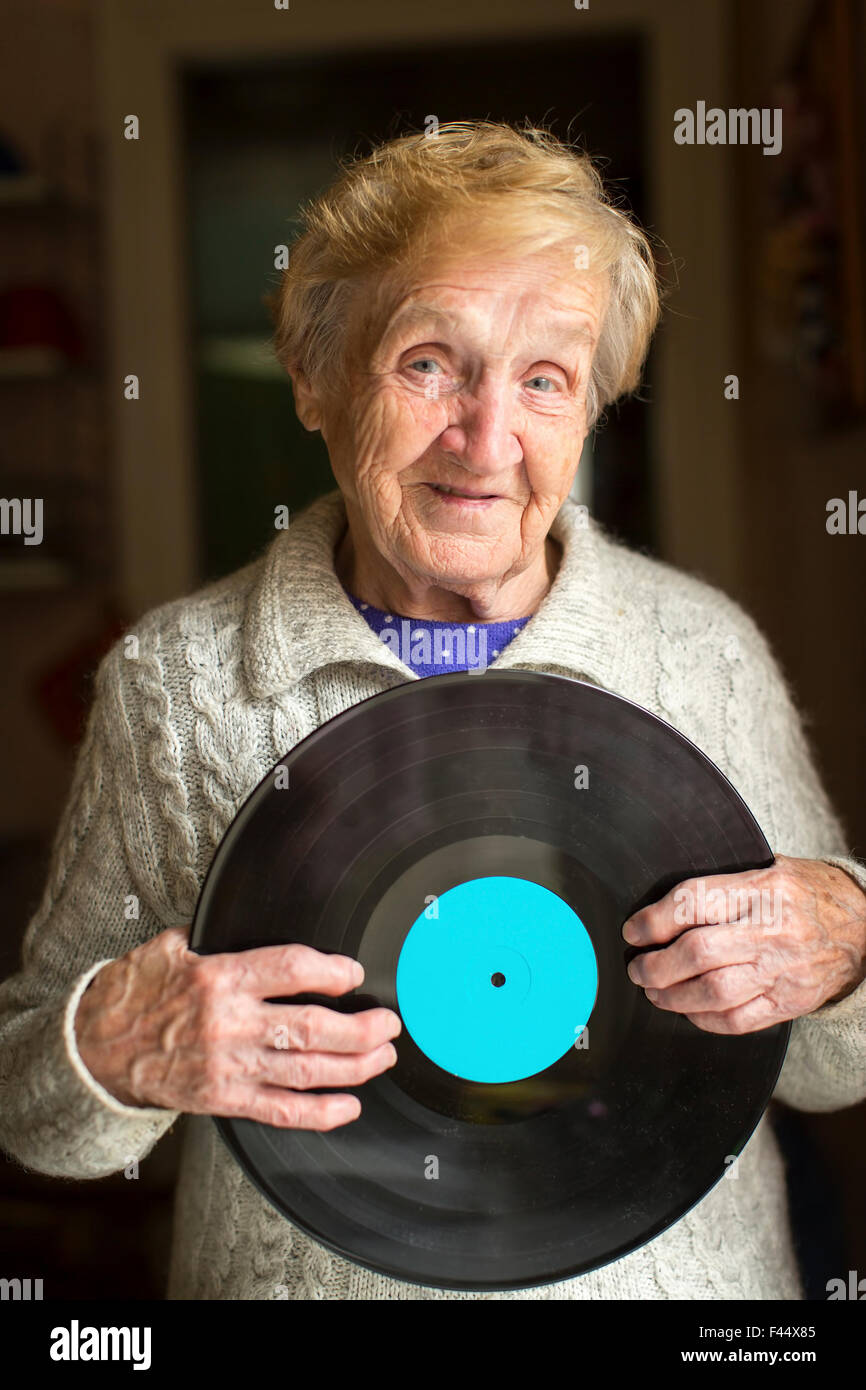 Old woman holding an old LP vinyl record Stock Photo - Alamy