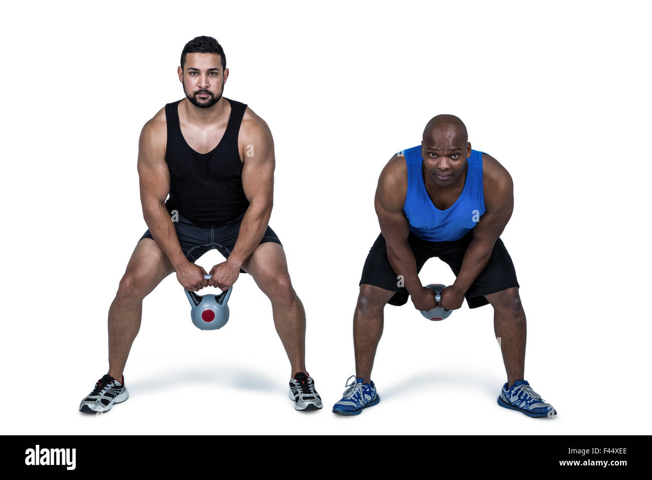 Strong friends lifting kettlebells together Stock Photo - Alamy