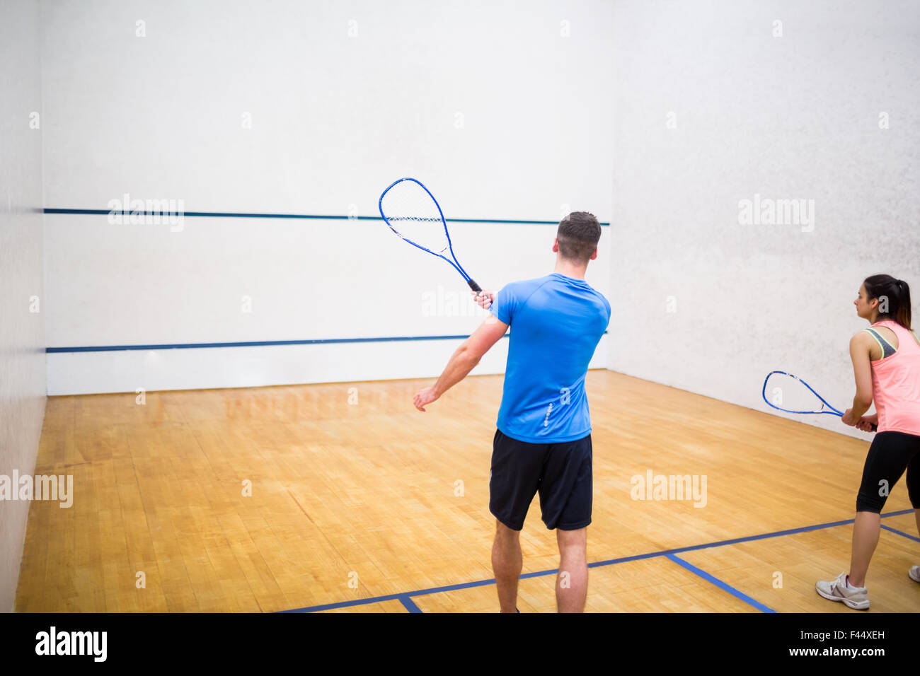 Couple play some squash together Stock Photo - Alamy