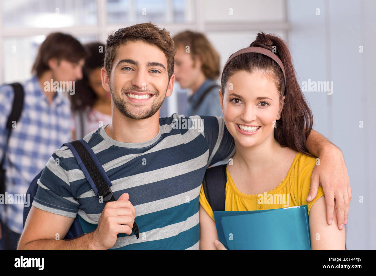 Happy students in college Stock Photo - Alamy
