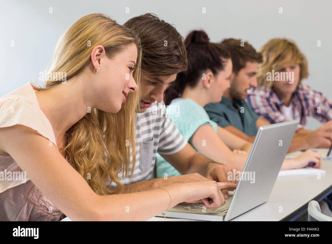 Students using laptop in classroom Stock Photo - Alamy
