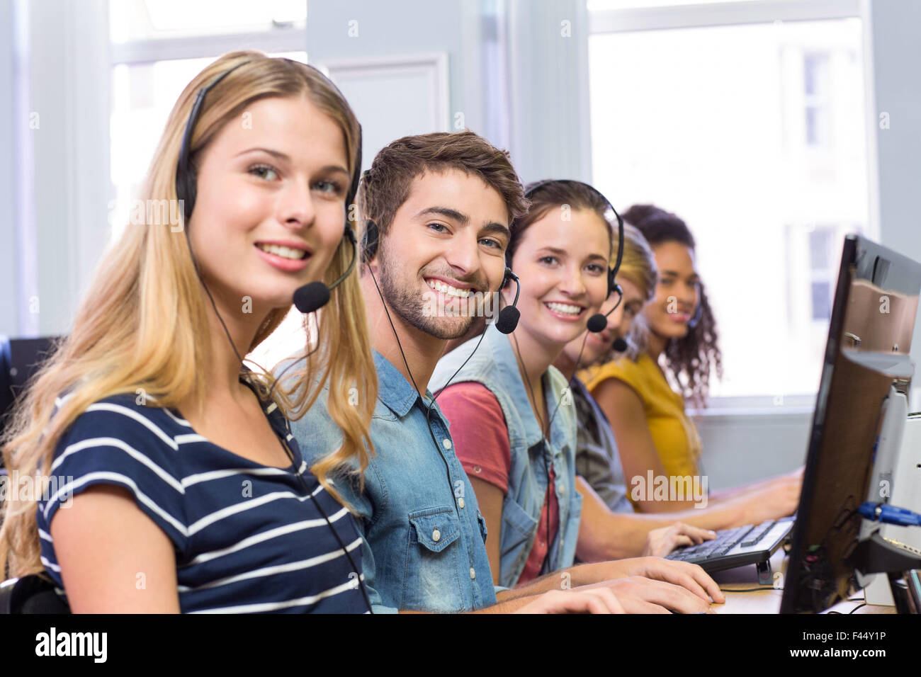 Students using headsets in computer class Stock Photo - Alamy