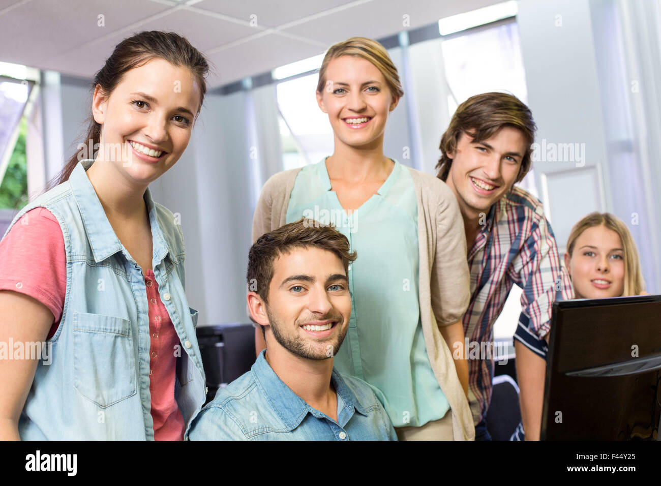 Happy female computer teacher and students Stock Photo - Alamy