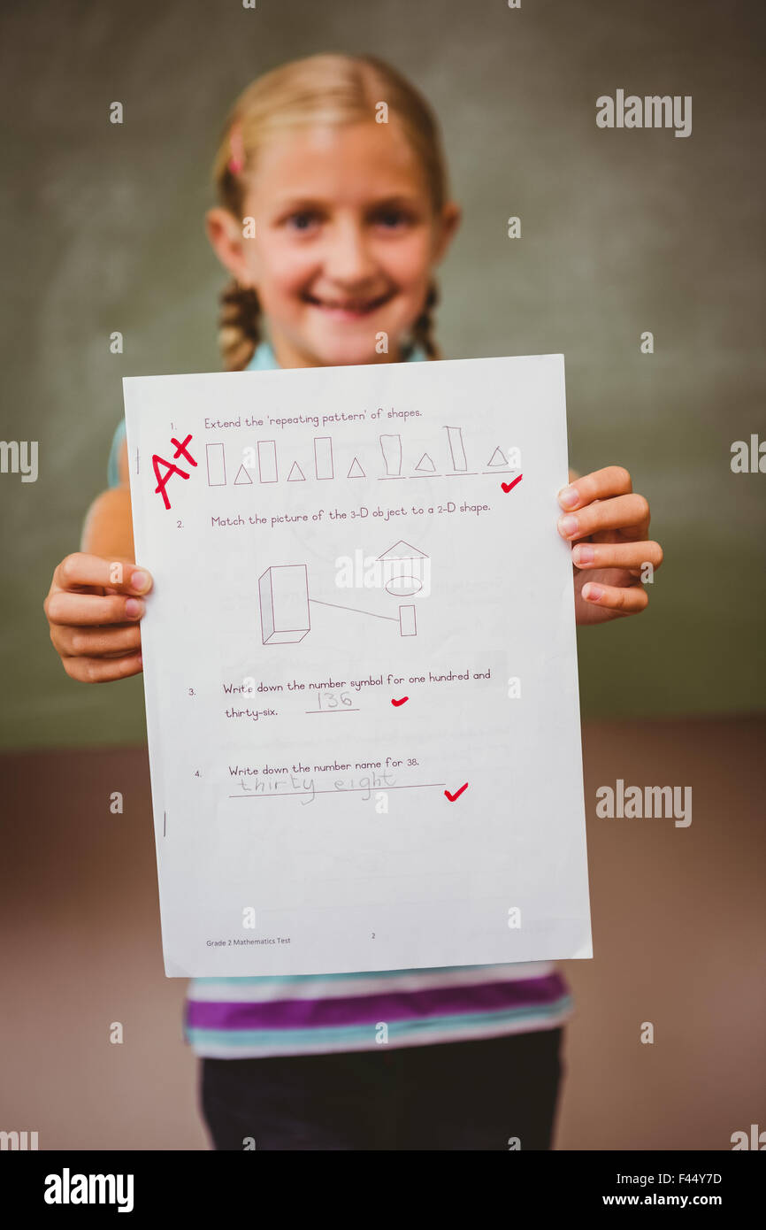 Portrait of cute little girl holding paper Stock Photo - Alamy
