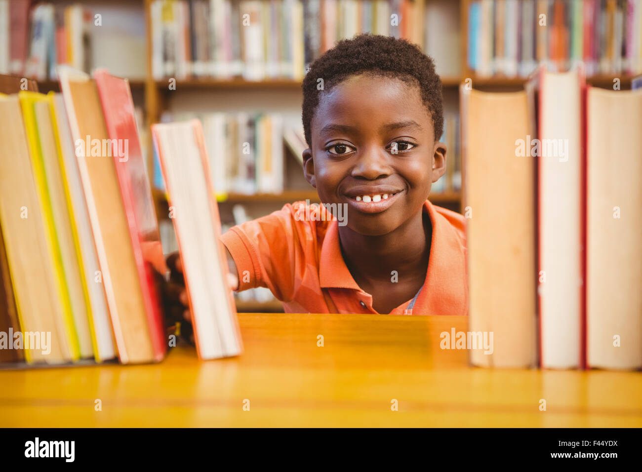 Portrait of cute boy in library Stock Photo - Alamy